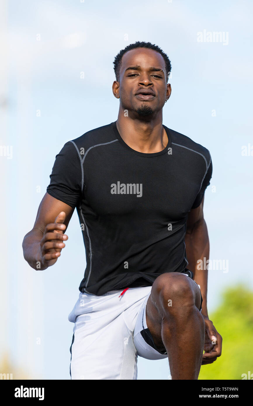 Black african american young man running outdoor Stock Photo - Alamy