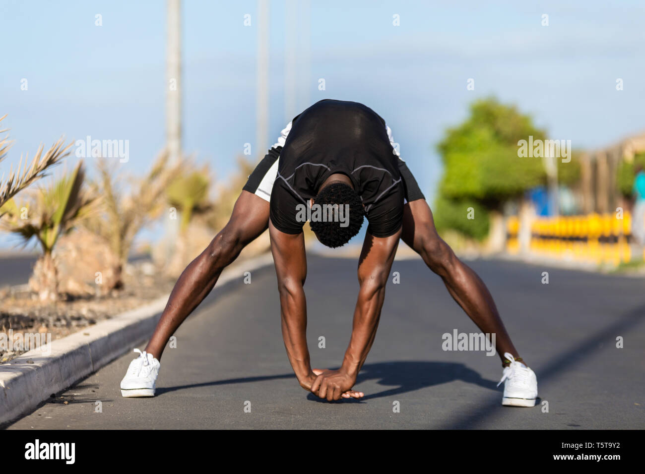 Black african american young man stretching after outdoor jogging Stock ...