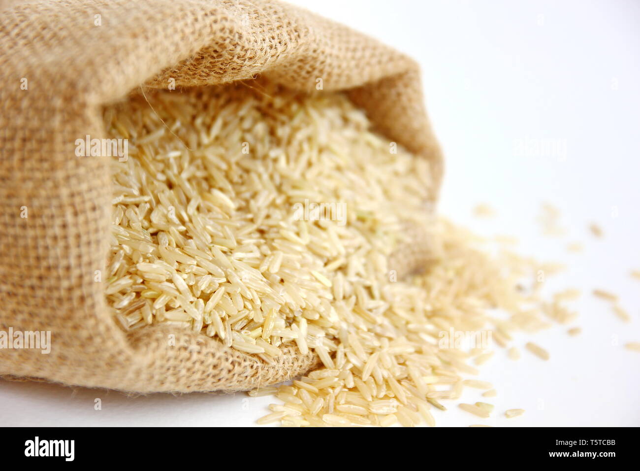 organic rice in sack on white background Stock Photo - Alamy