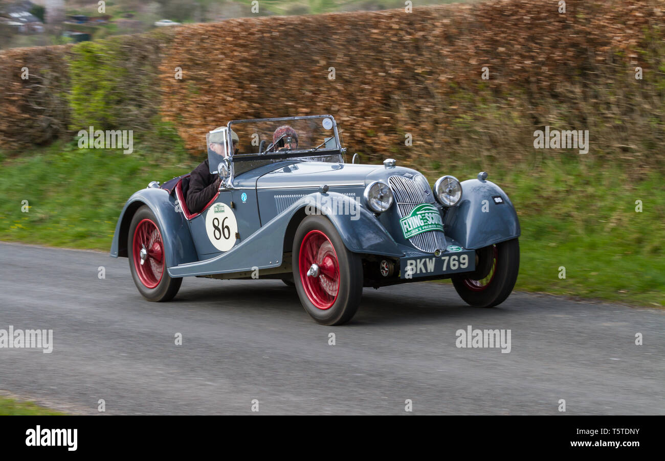 A 1937 Riley Sprite climbs Southwaite Hill in Cumbria, England. The car ...