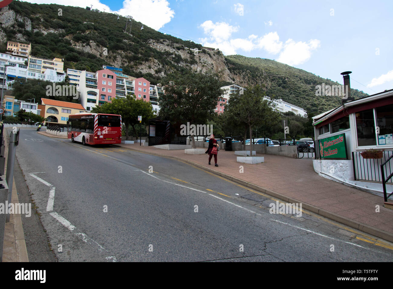 Gibraltar rock building bus stop red houses road path person walking ...