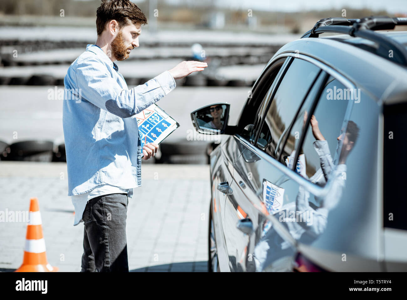 Instructor explaining the route scheme of training for a driver who ...
