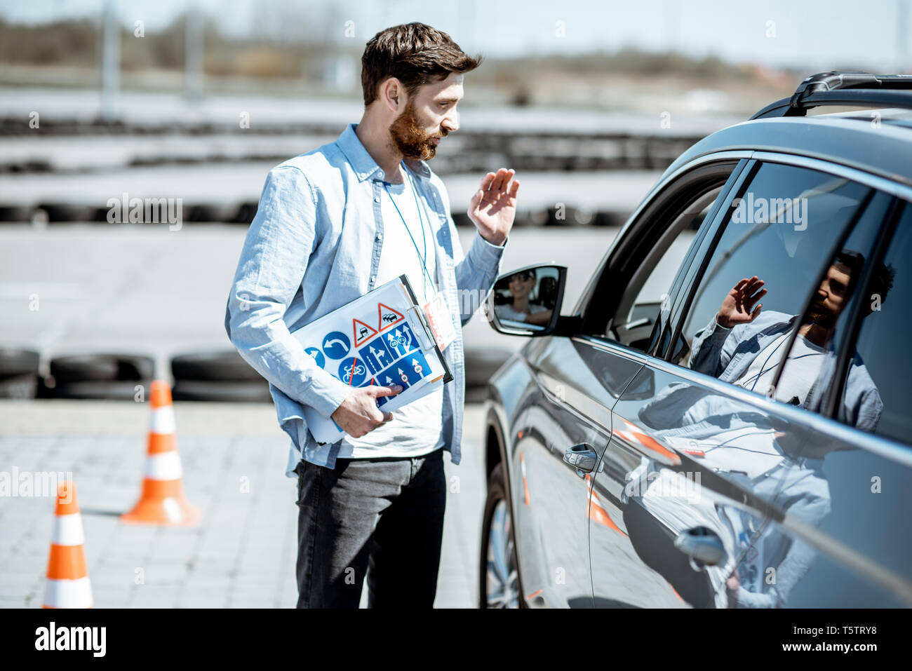 Instructor explaining the route scheme of training for a driver who ...
