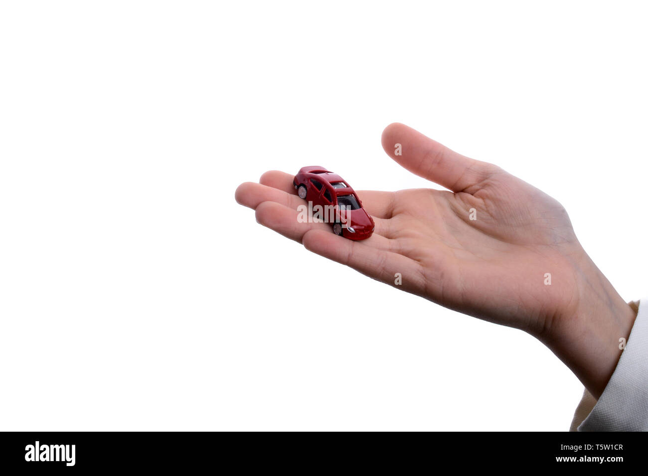 Child's hand holding a red car on a white background Stock Photo - Alamy