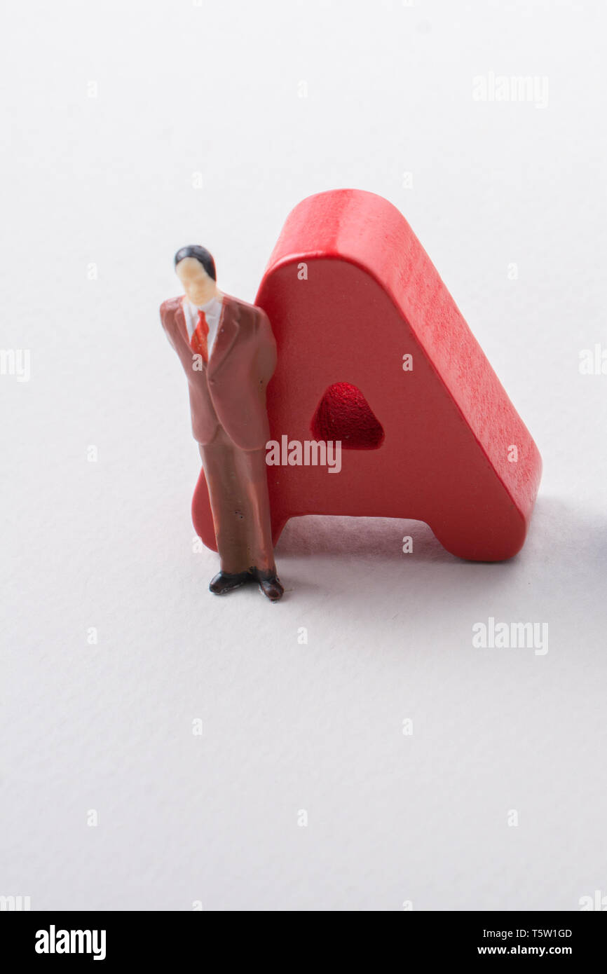 Man figurine and Letters of abc of alphabet on white Stock Photo - Alamy