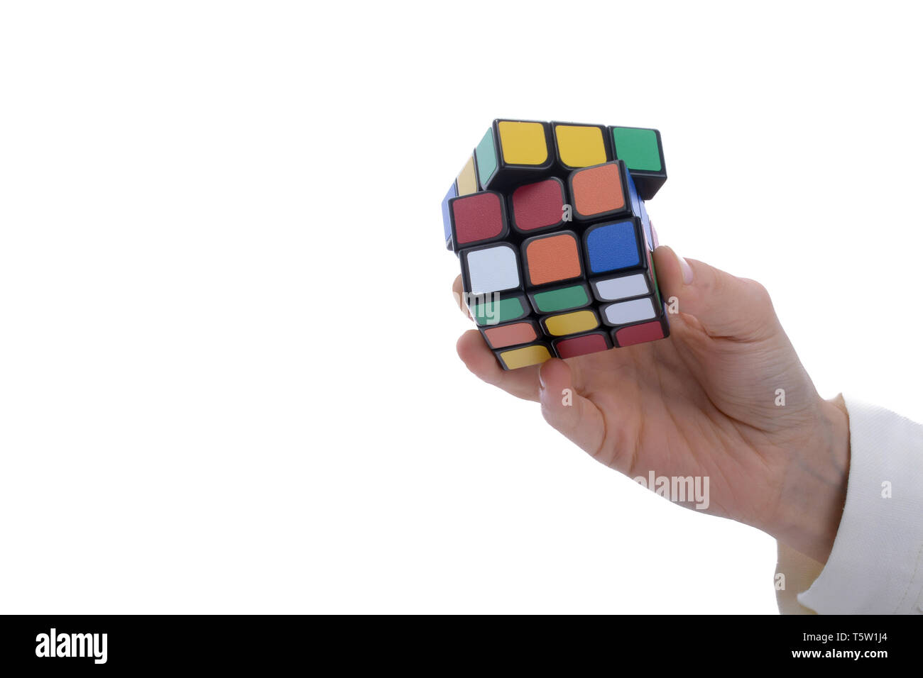 Child holding a Rubik's cube in hand on a white background Stock Photo ...