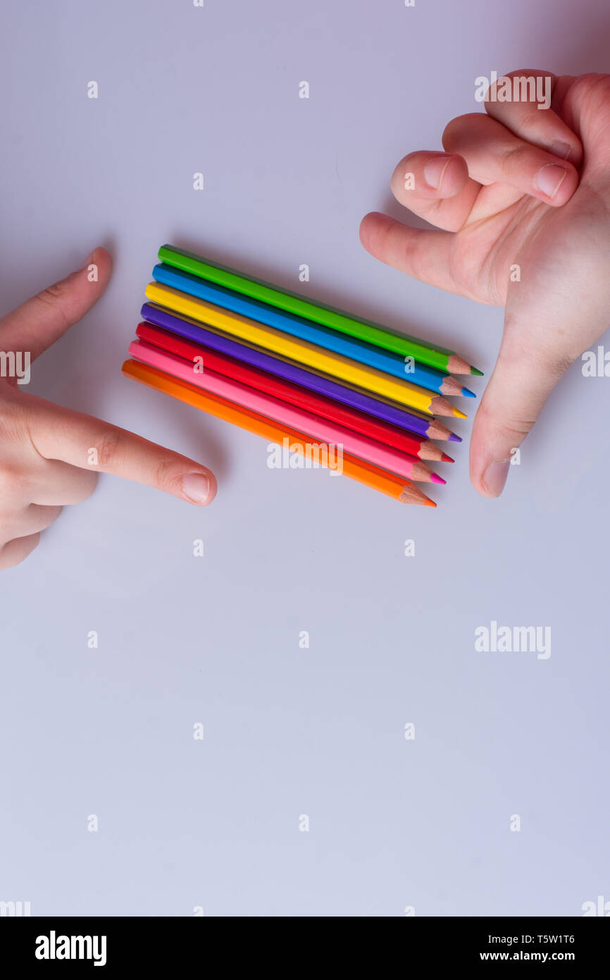 Hand holding color Pencils placed on a white background Stock Photo - Alamy