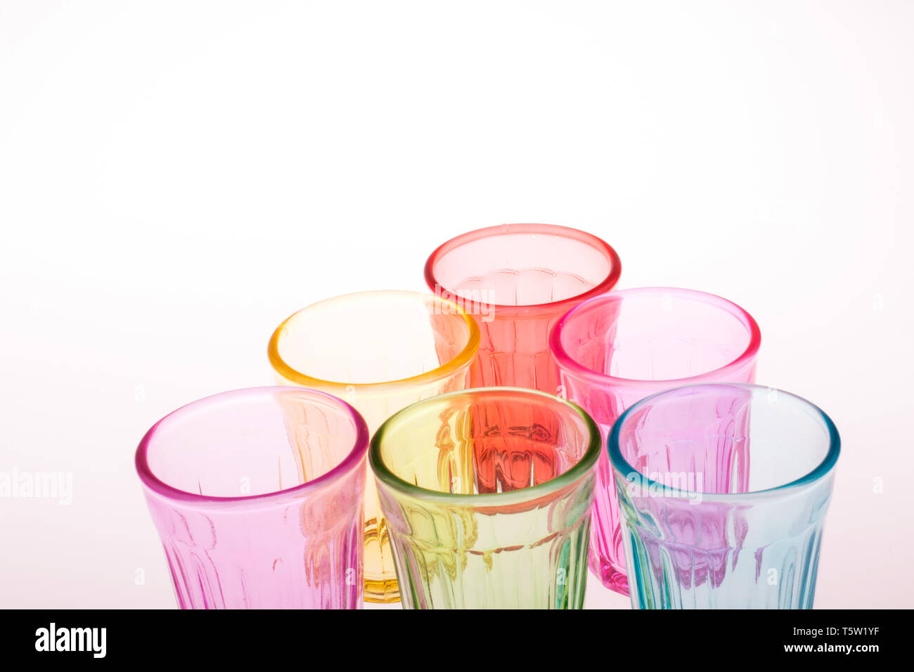 Colorful drinking glasses on white background Stock Photo - Alamy
