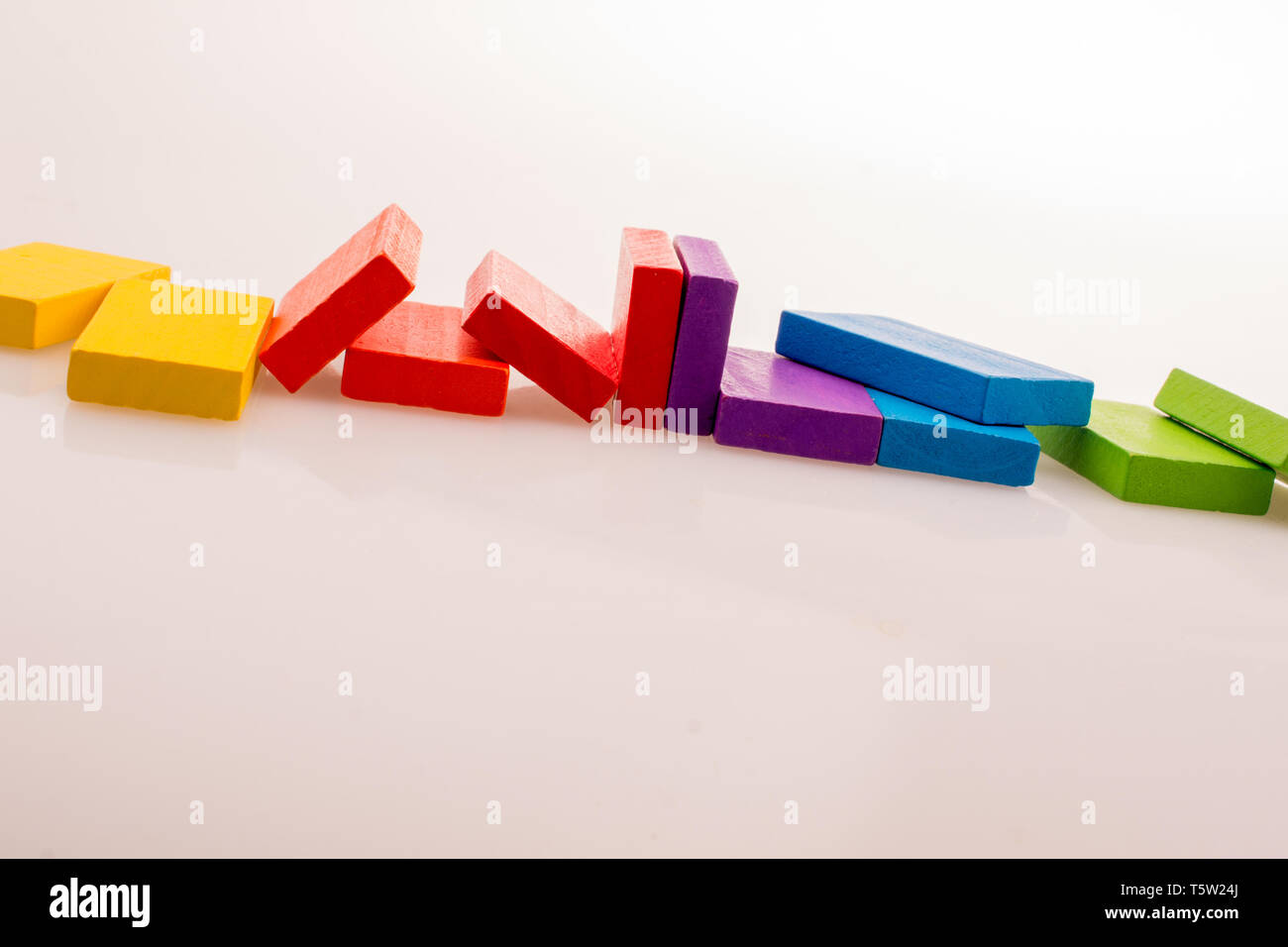 Colorful Domino Blocks in a line on a white background Stock Photo - Alamy