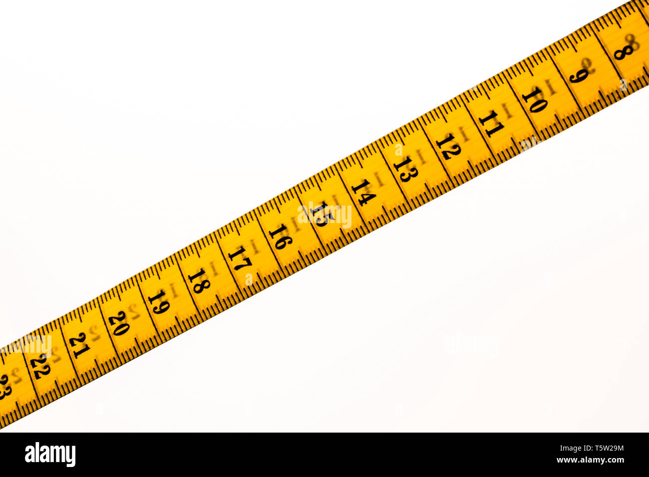 Yellow color Tape measure roll on a white background Stock Photo - Alamy
