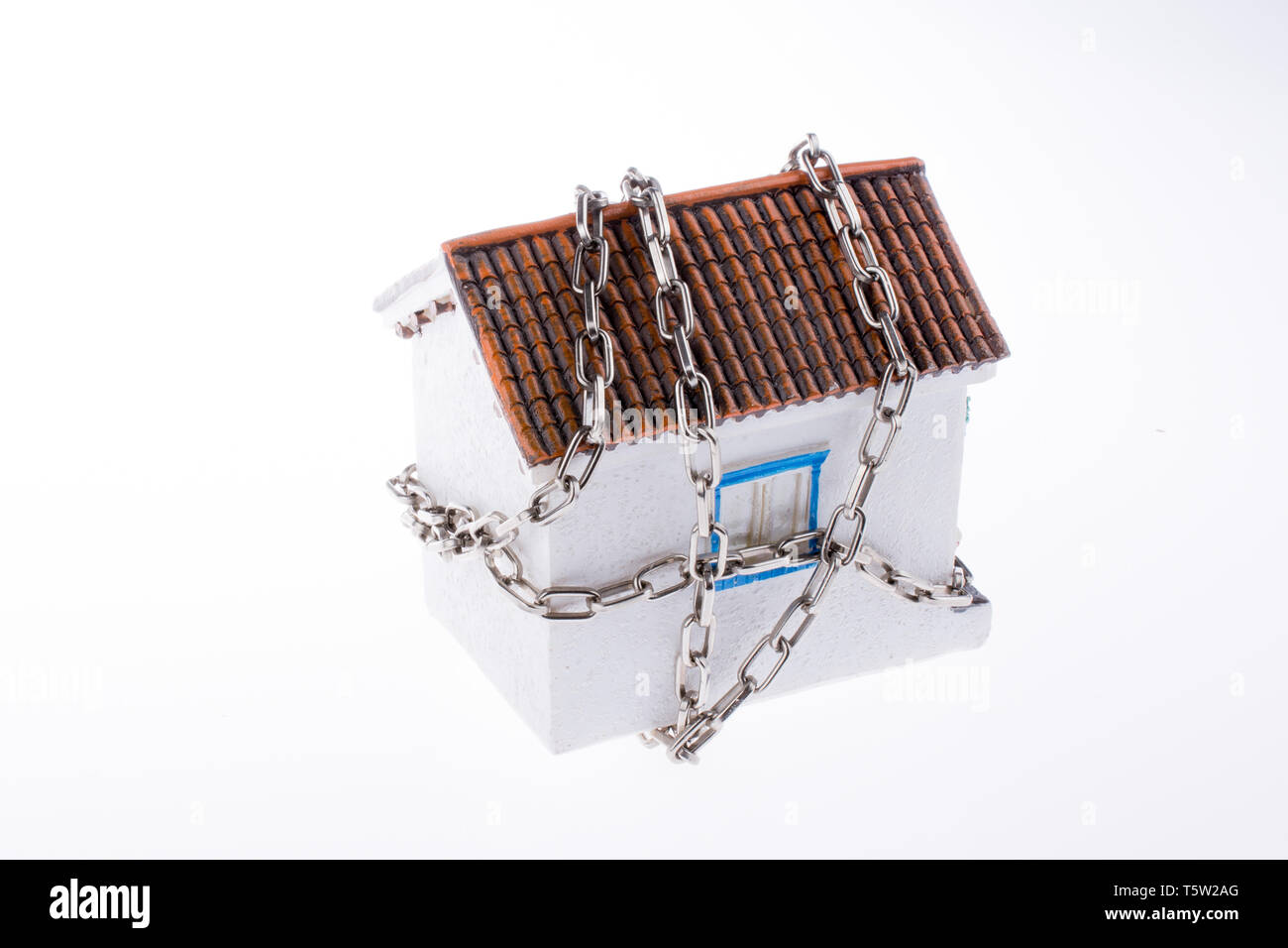 house in chains on a white background Stock Photo - Alamy