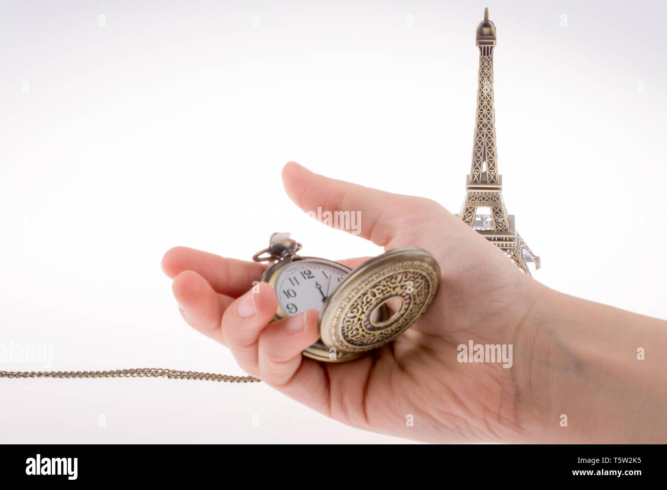 Hand holding a pocket watch befere Eifel Tower Stock Photo - Alamy