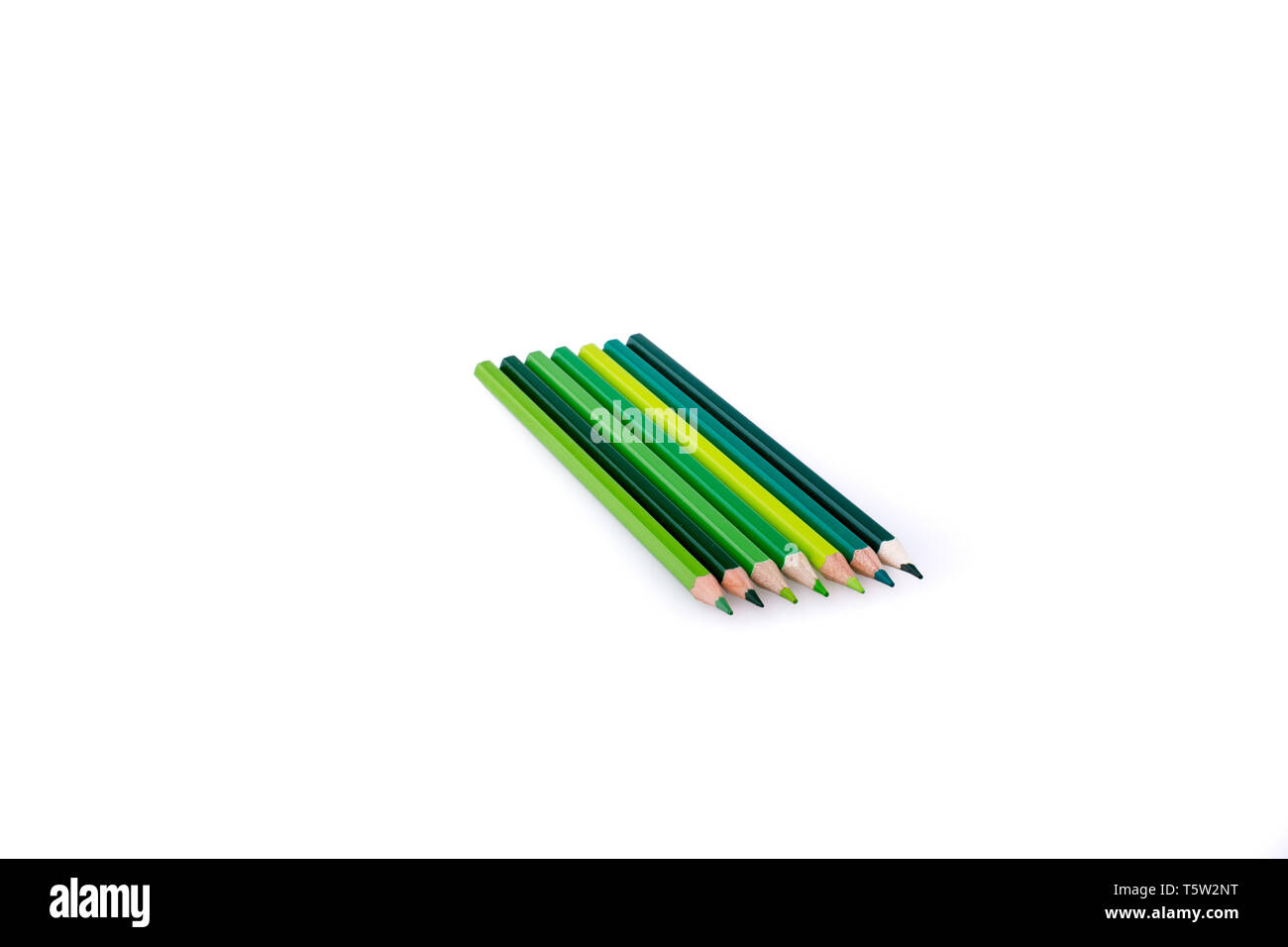 Color Pencils of various tones of green color on a white background ...