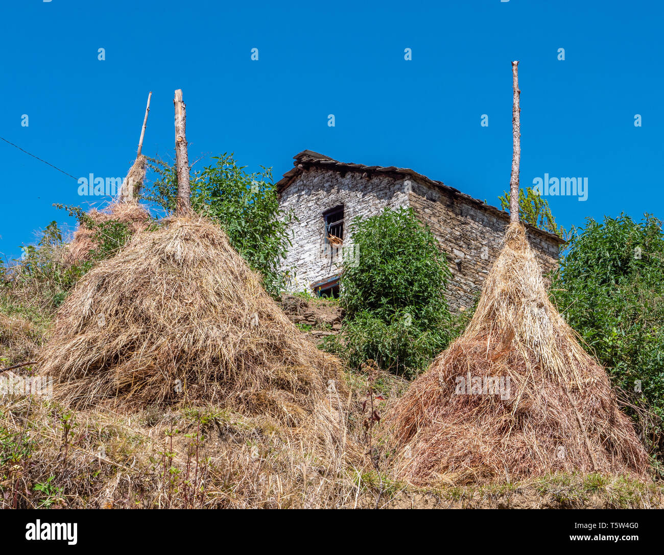 Haystack poles and farm building in the mountain village of Risal in ...