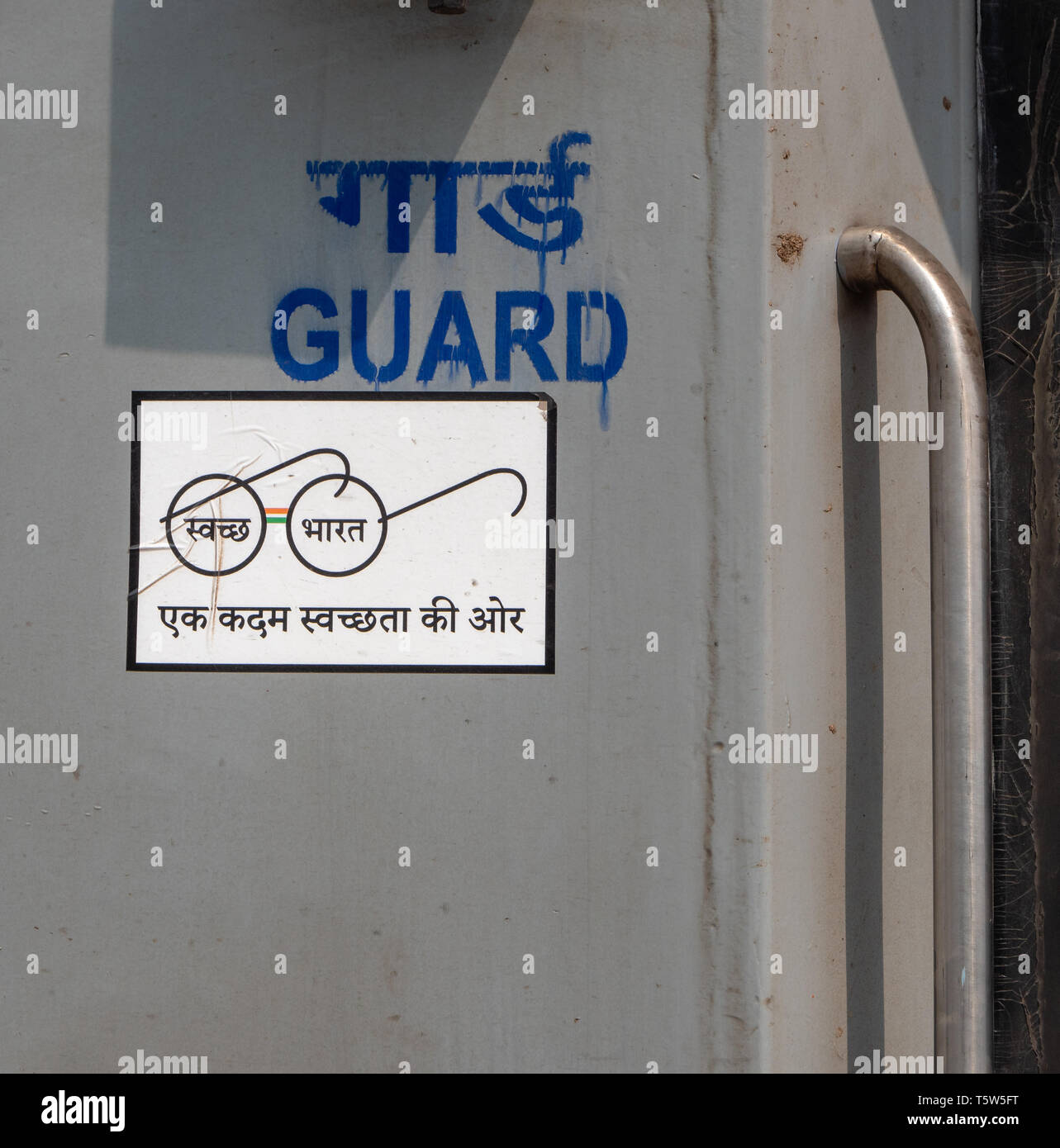 Sign with symbolic Gandhi spectacles on a carriage of an Indian ...