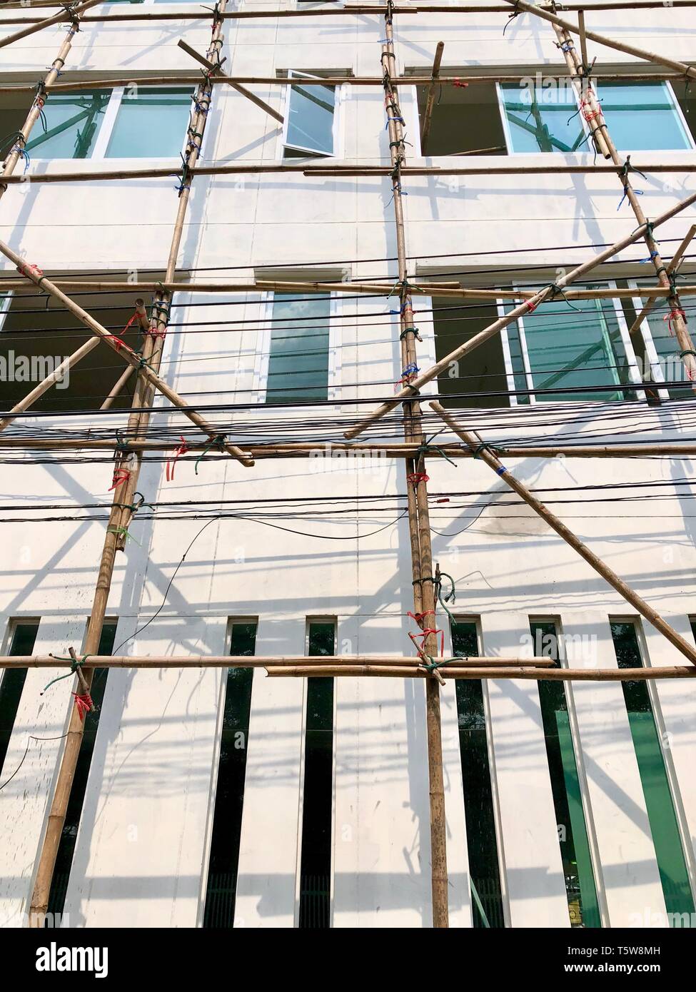 huge bamboo sticks are tile together to be base on painter, climb up ...