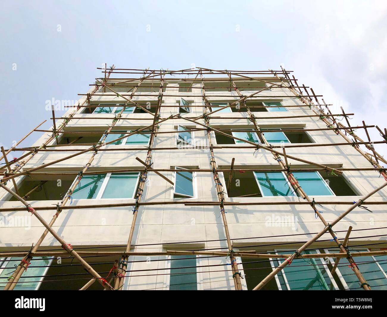 huge bamboo sticks are tile together to be base on painter, climb up ...