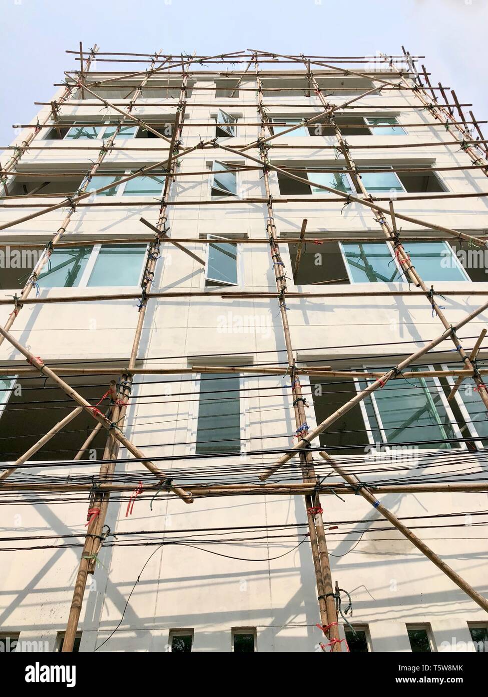 huge bamboo sticks are tile together to be base on painter, climb up ...