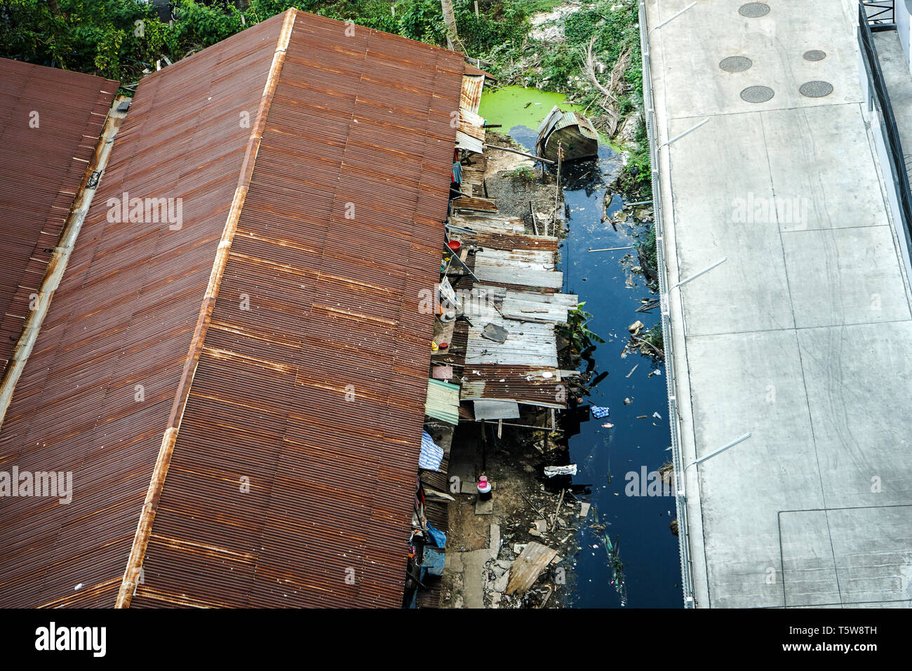 slum zone, photo shooting from top view, can see rust rooftop, garbage ...