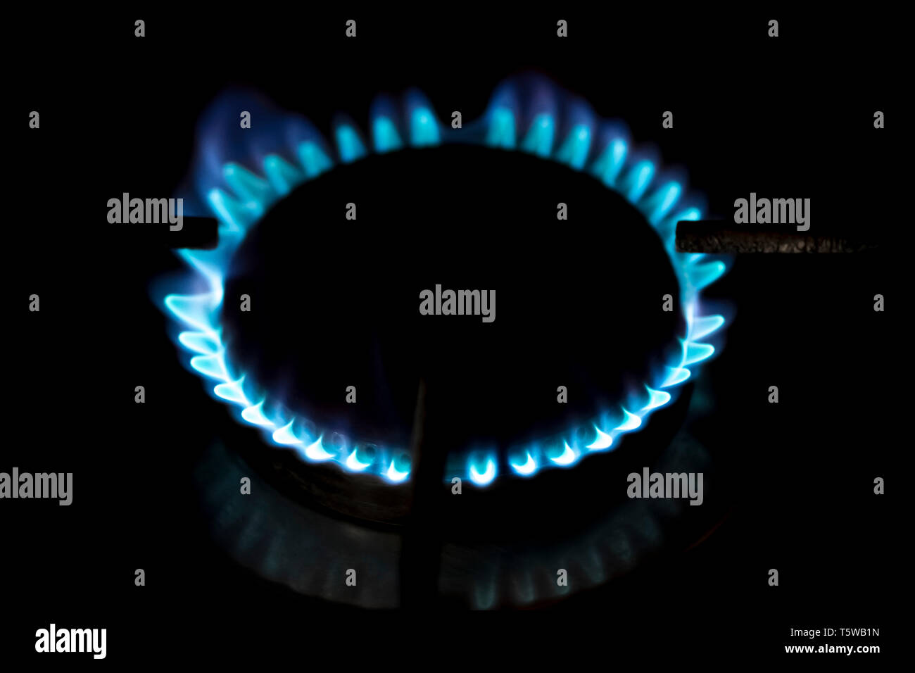 burning blue flame gas on the stove in the kitchen in the dark Stock ...