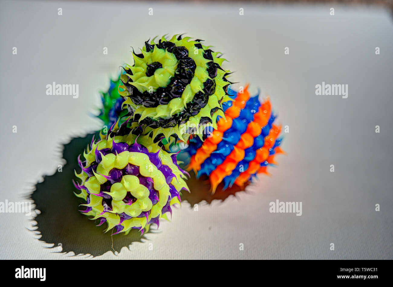 Multi colored striped balls with spikes Stock Photo - Alamy