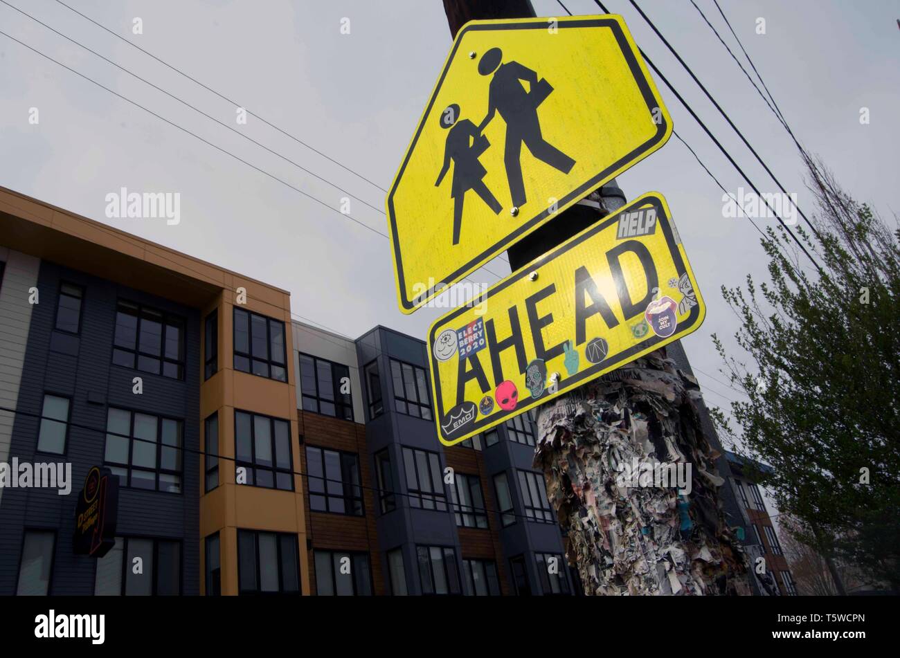 A traffic sign in Portland, OR, is cluttered with old stickers Stock ...