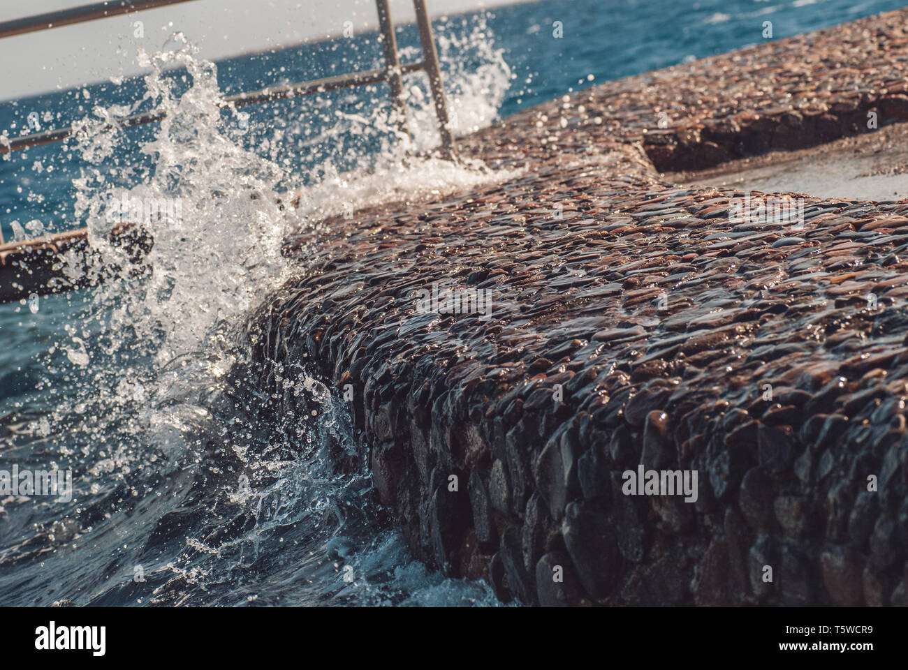 Giant Ocean waves hitting stone pier during storm. Vacation summer ...
