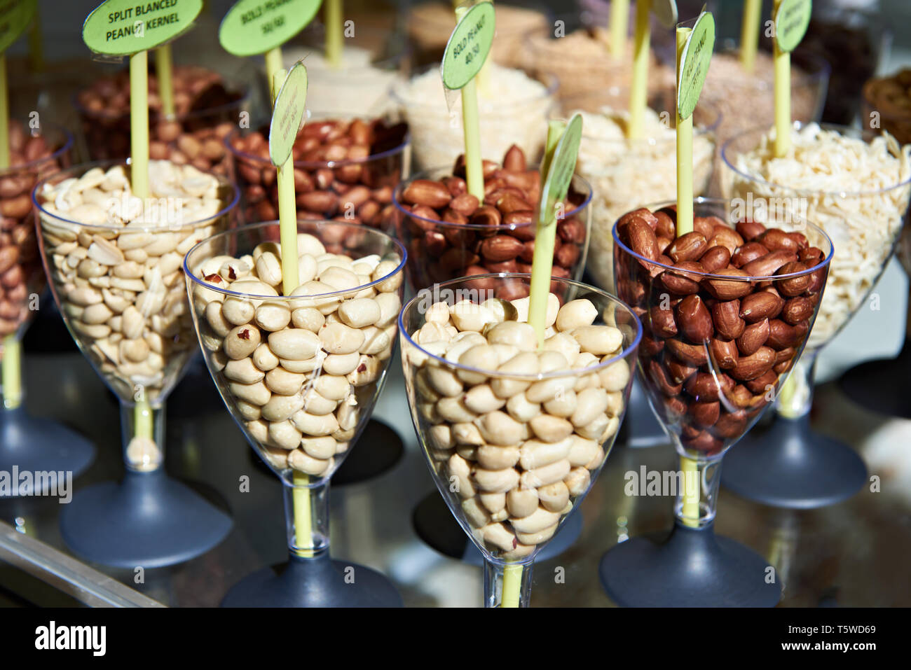 Different peanuts nuts in glass goblets on display in a store Stock ...