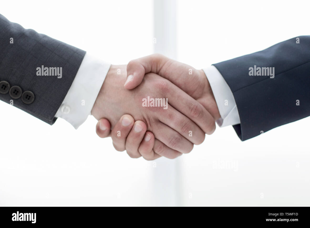 close up.handshake of business partners on a light background.concept ...