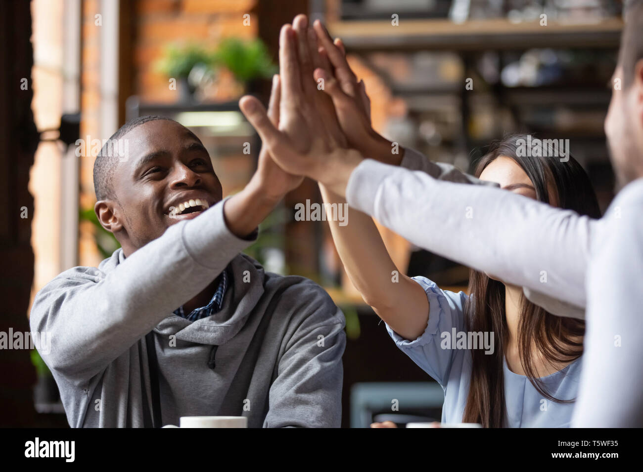 Community cafe high five hi-res stock photography and images - Alamy