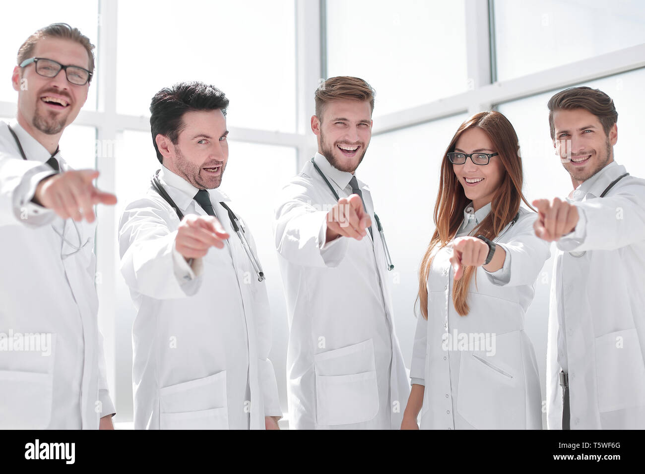 health and medical concept. a group of practicing doctors pointing ...