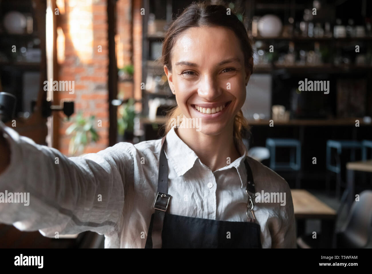Restaurant employee in apron smiling hi-res stock photography and ...
