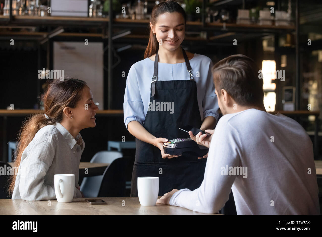 Client in cafe paying using mobile application NFC payment Stock Photo ...