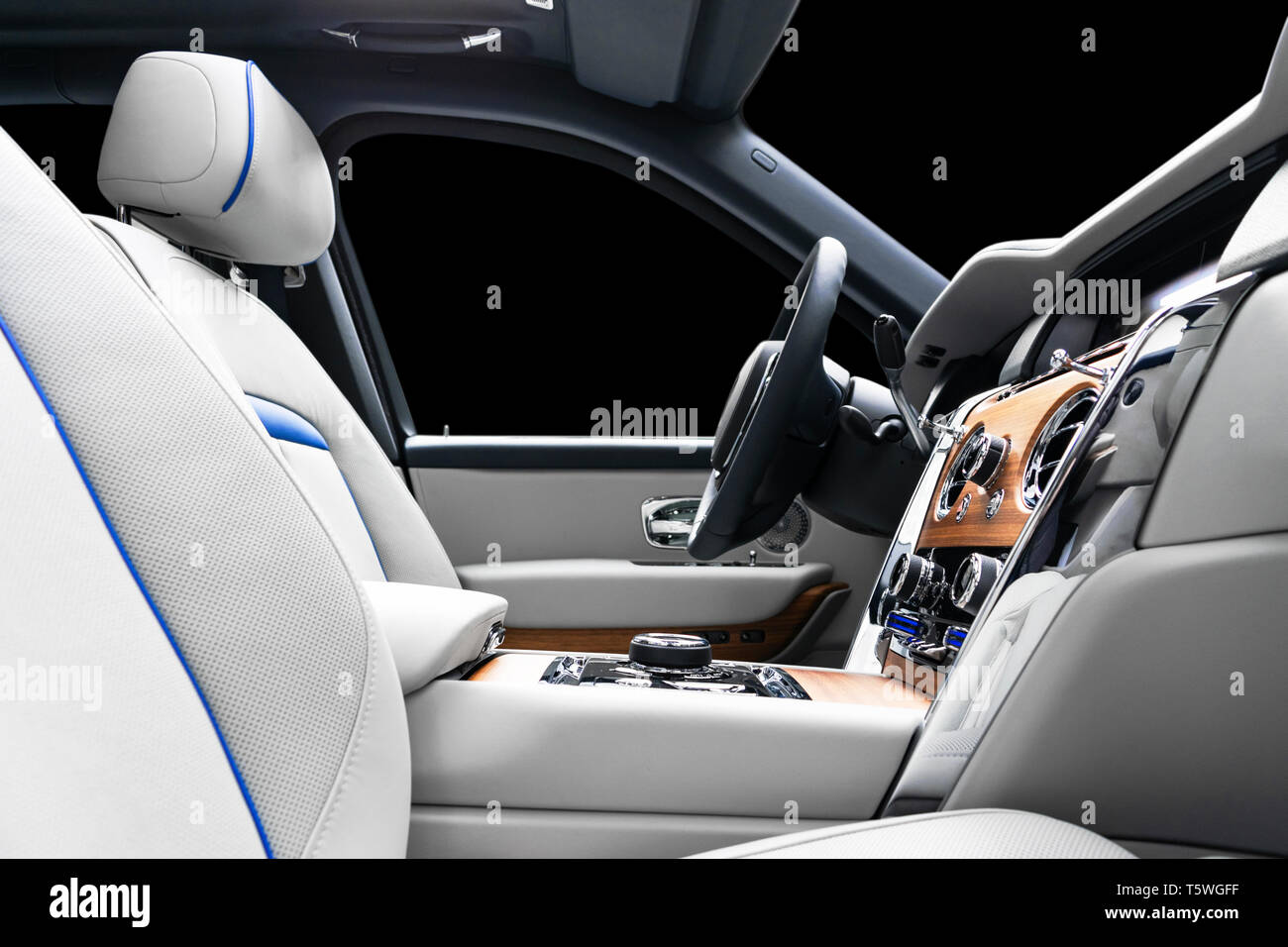 Modern luxury car white leather interior with natural wood panel. Part of leather car seat ...