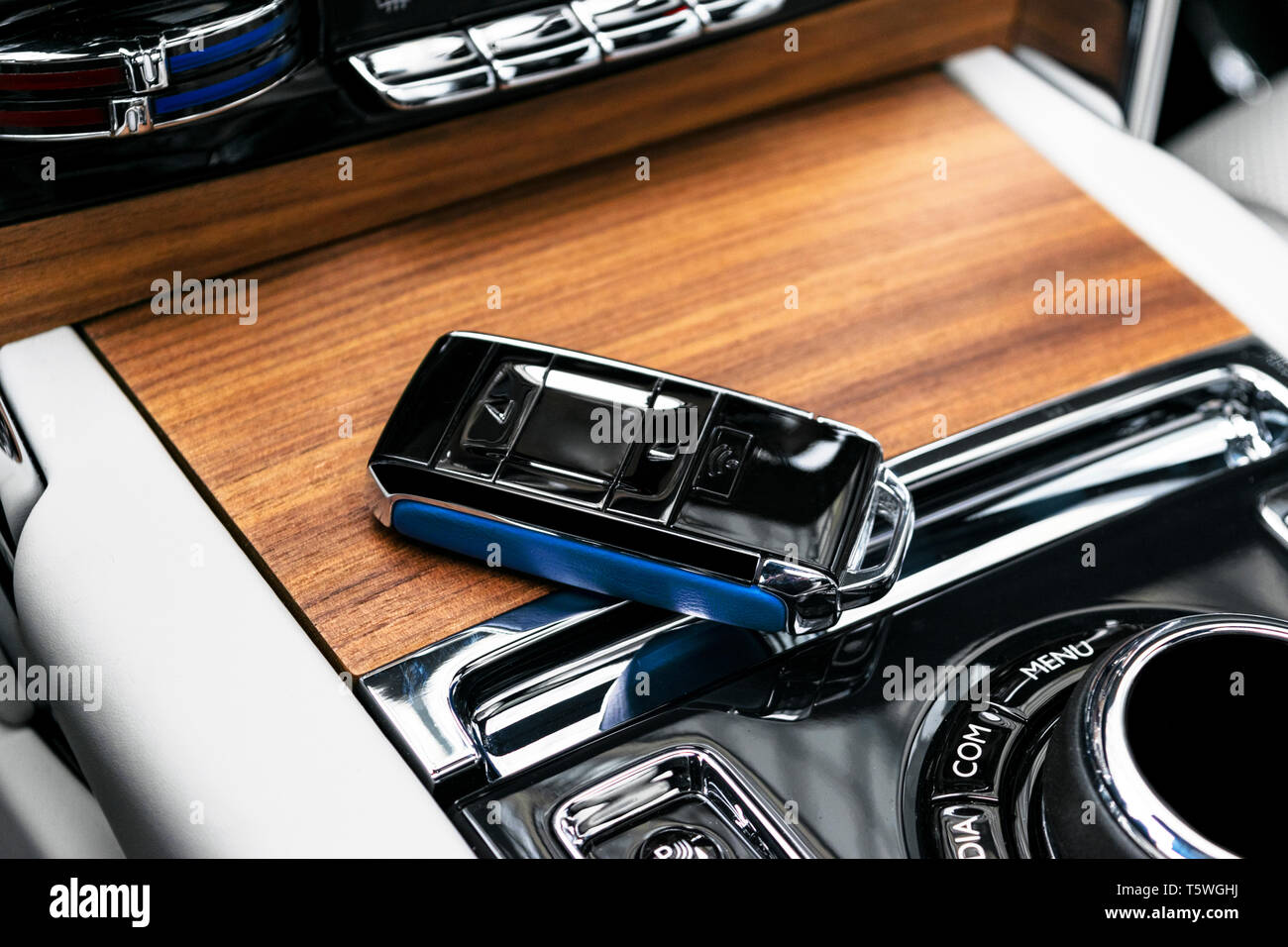 Closeup inside vehicle of wireless blue leather key ignition on natural ...