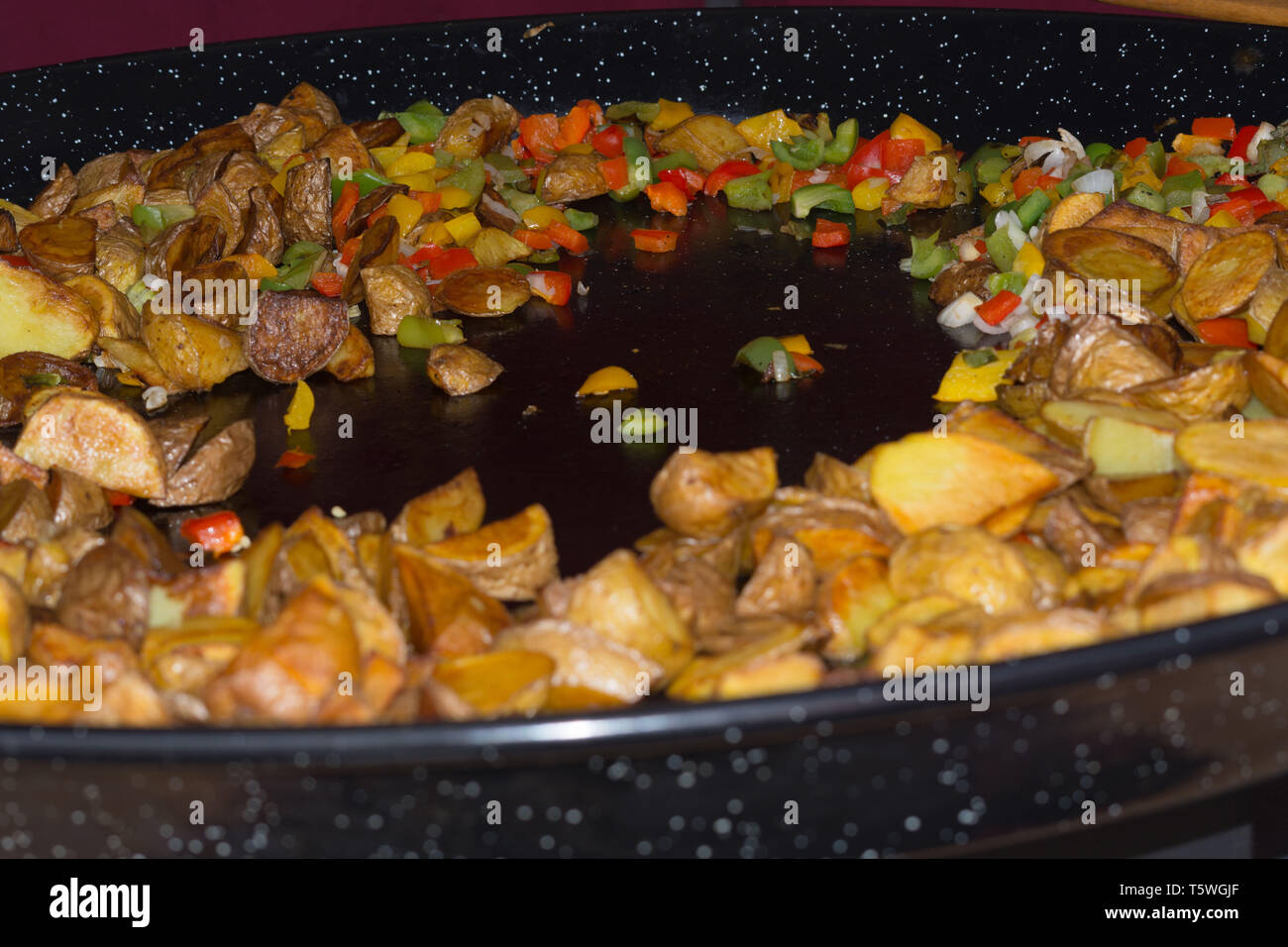 Yummy medieval stir fry in a big old iron pan Stock Photo - Alamy