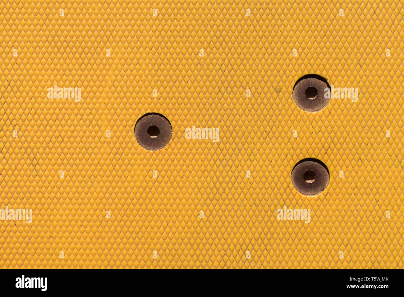 Yellow plastic background texture with diamond shape pattern and rusty ...