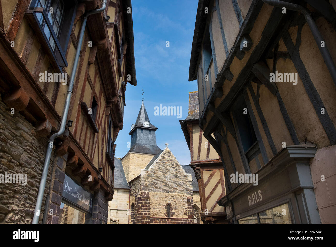 Half timbered buildings either side of a narrow street in the town of ...