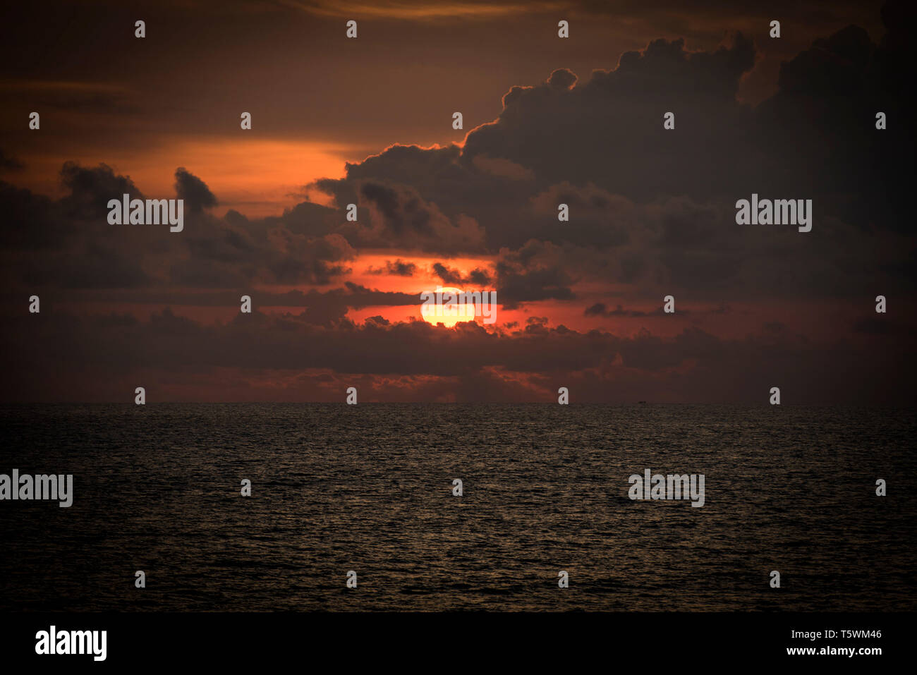 Sun sets above the sea in Bali, Indonesia Stock Photo - Alamy