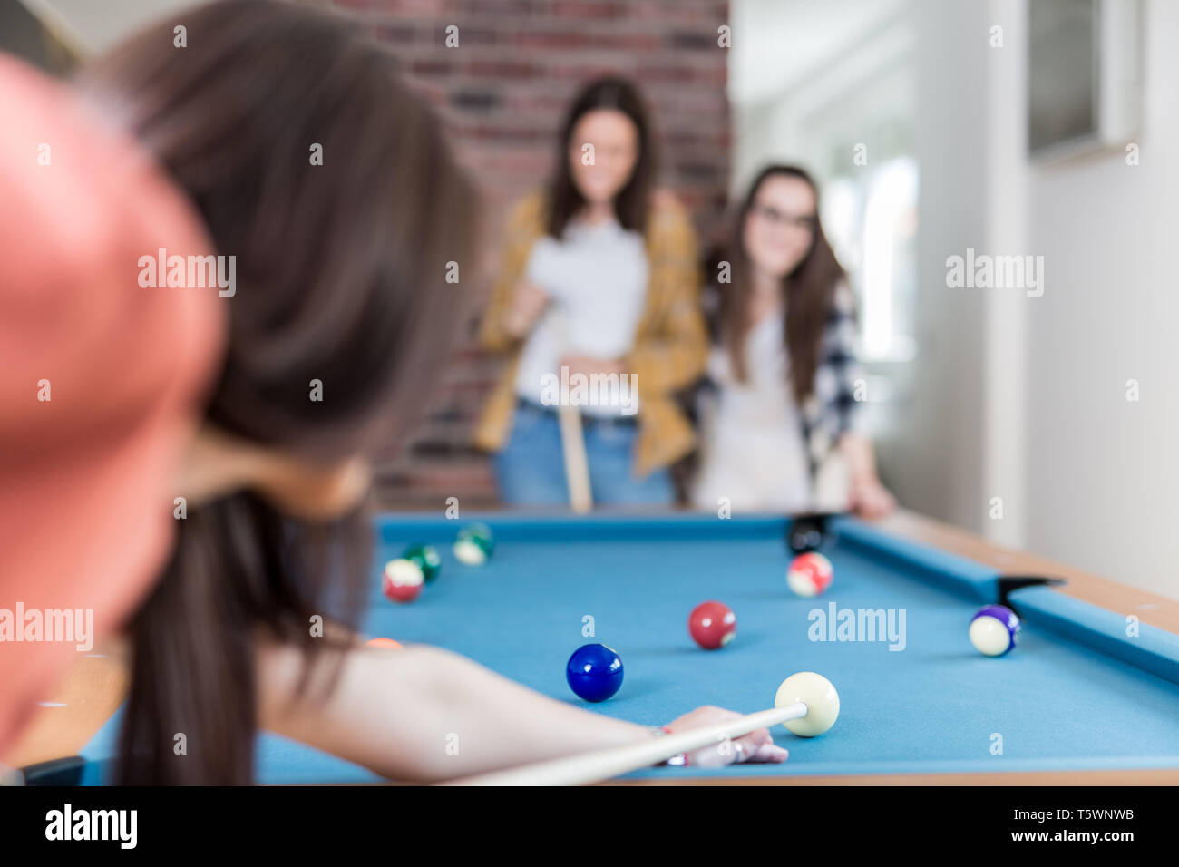 Group of friends enjoying snooker game Stock Photo - Alamy