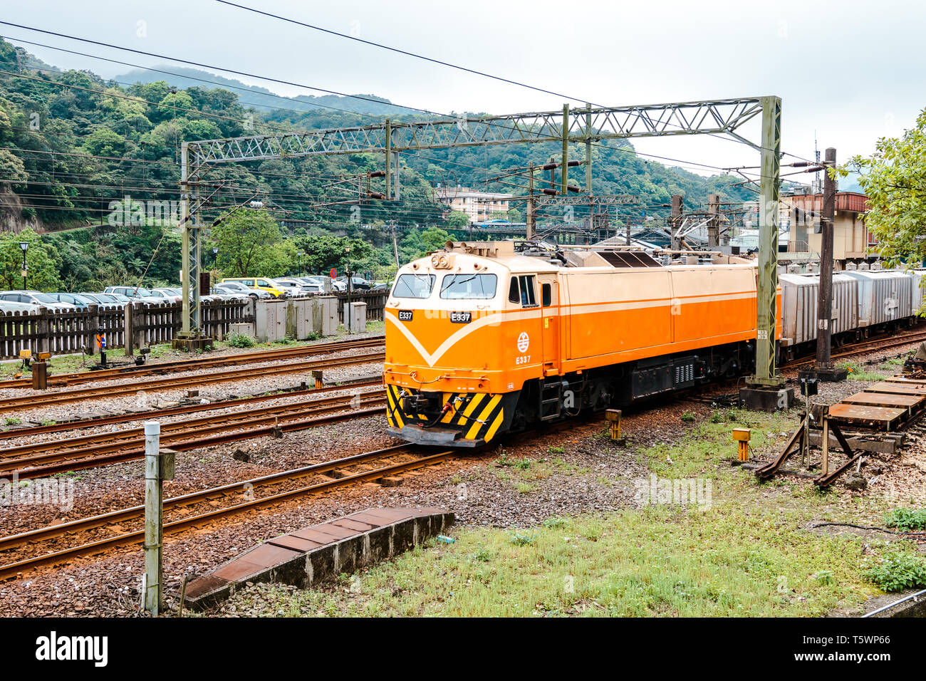 Orange Taiwan Railways Administration (TRA) Locomotive passing through ...