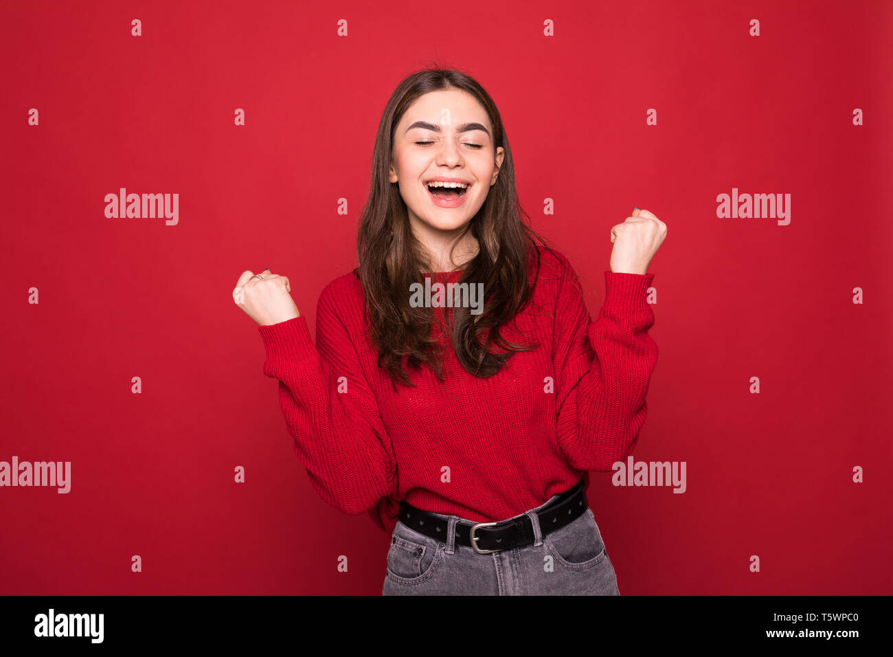 Portrait of cheerful happy young woman in lace dress, cap clenching fists like winner isolated ...
