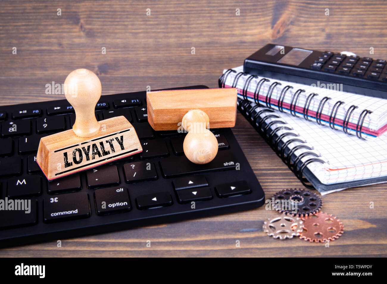 Loyalty concept. Computer keyboard and wooden stamps Stock Photo - Alamy