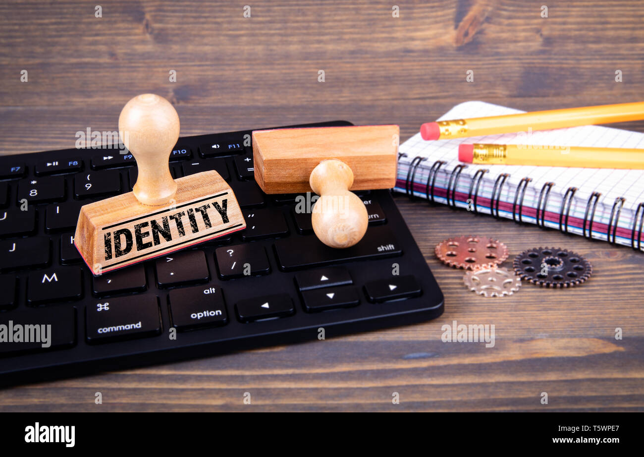 Identity concept. Computer keyboard and wooden stamps Stock Photo - Alamy