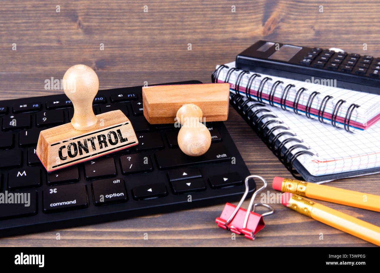 Control concept. Computer keyboard and wooden stamps Stock Photo - Alamy