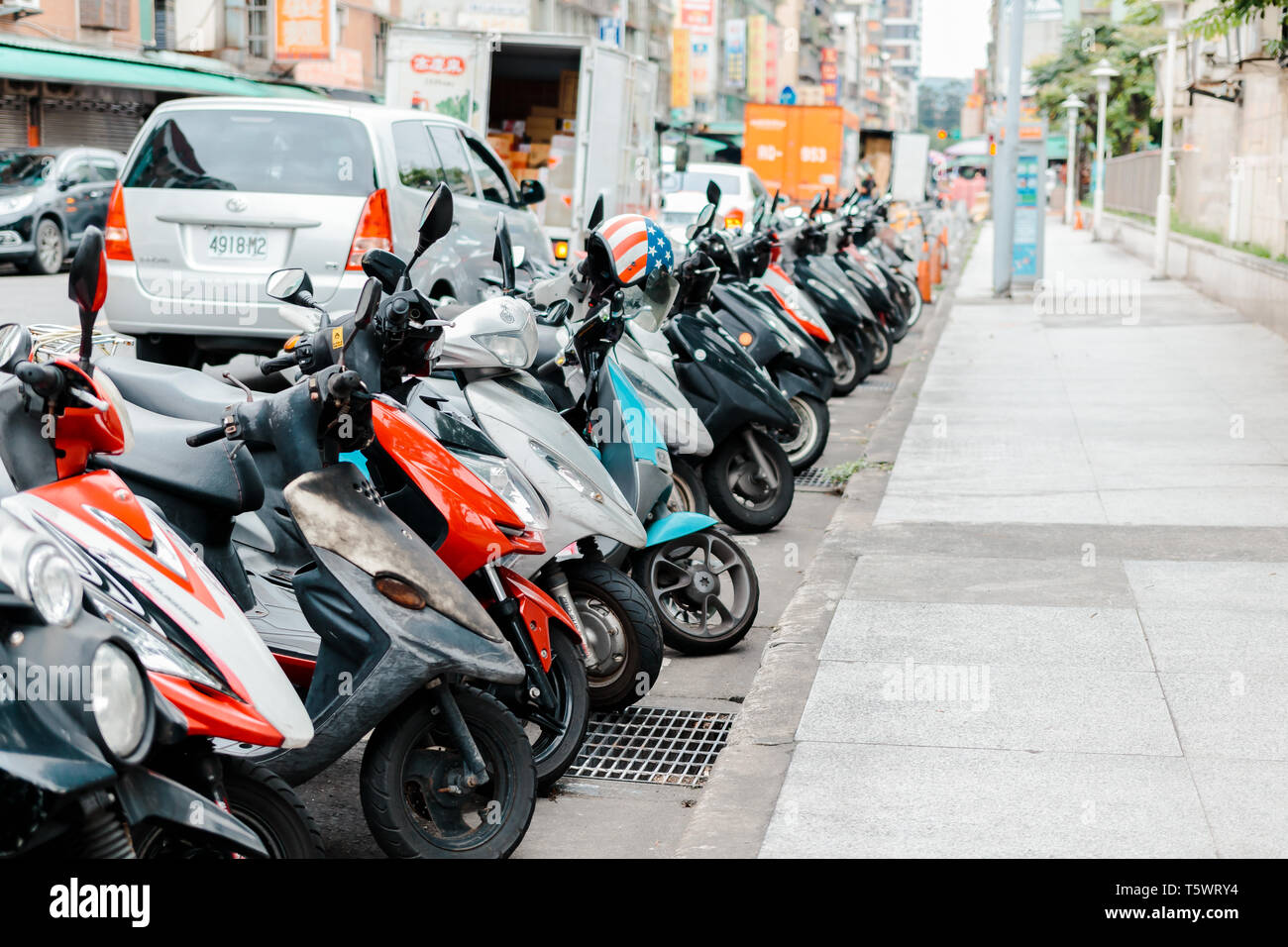 Row of motorcycle (motorbike) parking on the side of a street beside ...