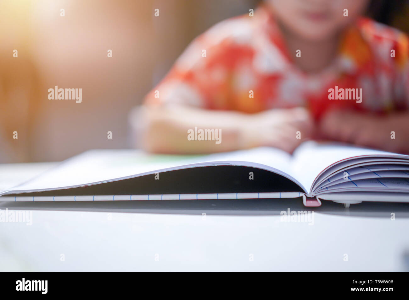 Asian girl kid concentrated read a book, close up & focus at the book ...