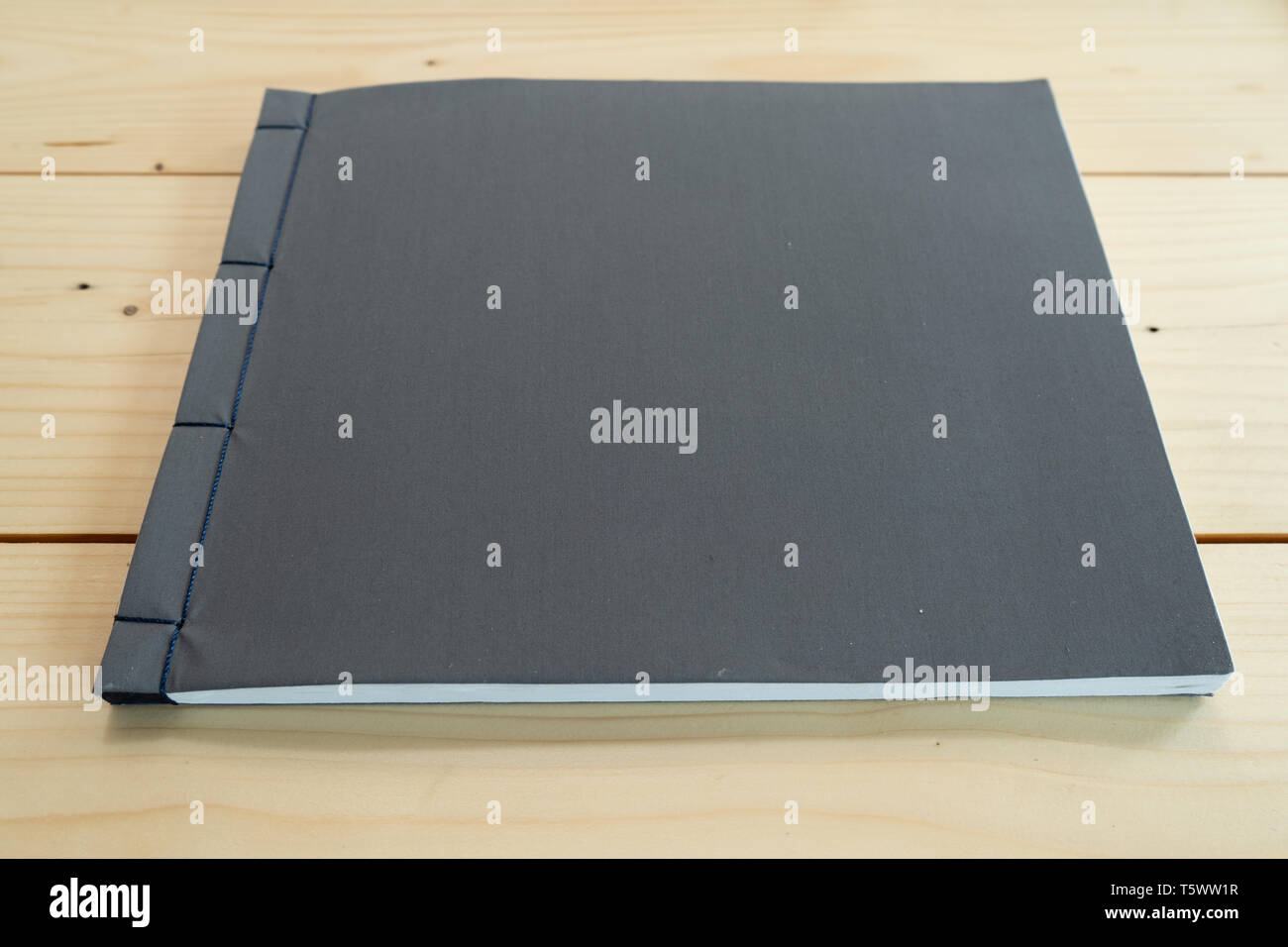classic black notebook on the wood table Stock Photo - Alamy