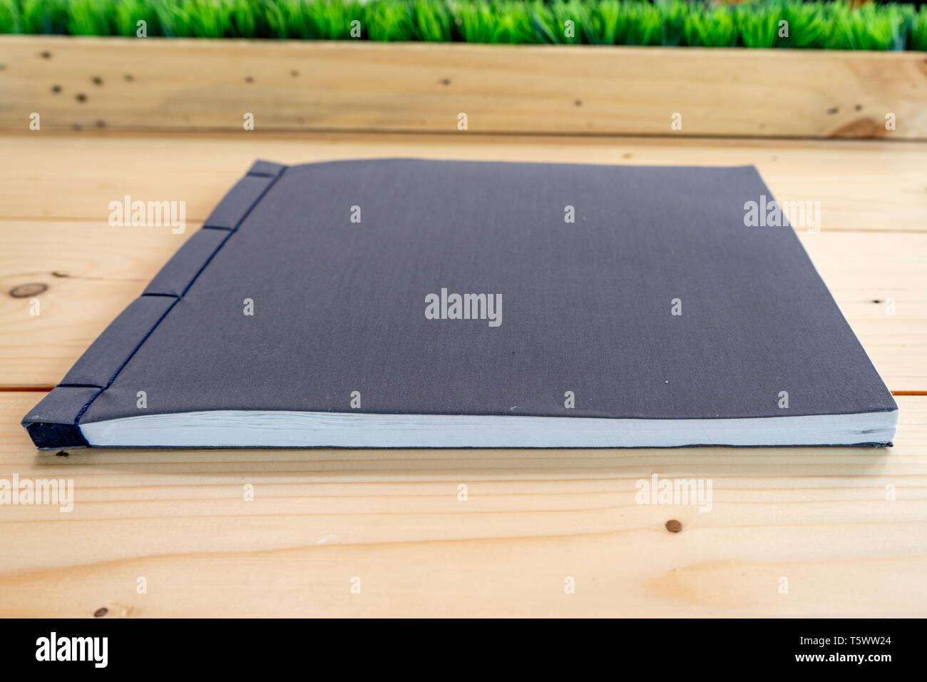 classic black notebook on the wood table Stock Photo - Alamy