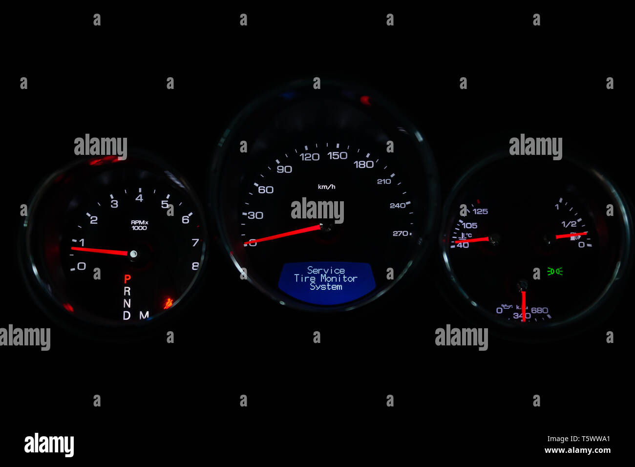 The dashboard of the car is glowing blue with red arrows at night with ...